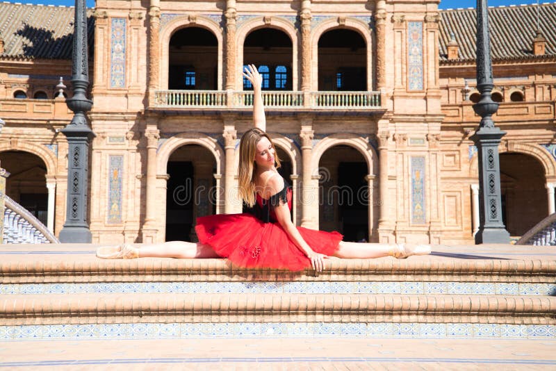 Classical Ballet Dancer in Red Tutu with Her Legs Open on the Steps of ...
