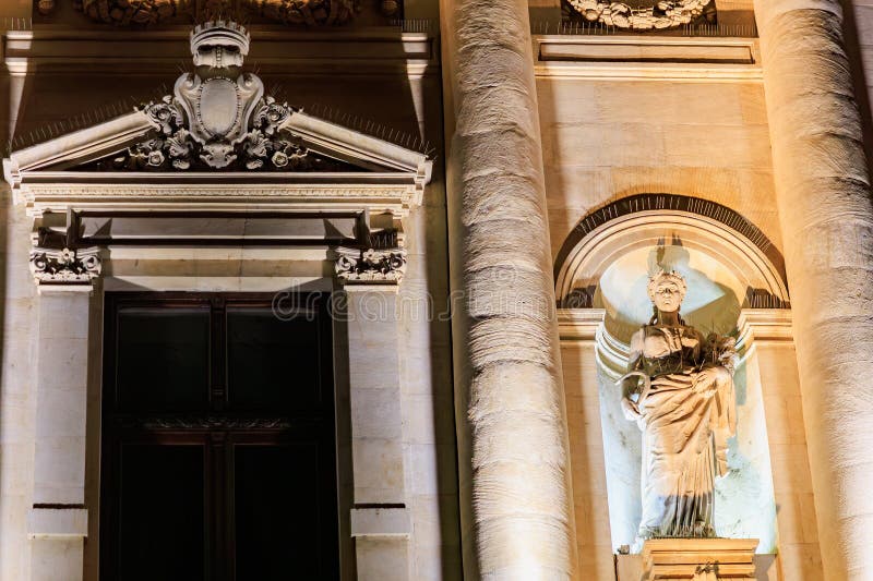 Classical Stone Statue Illuminated on Historic Building Facade at Night ...