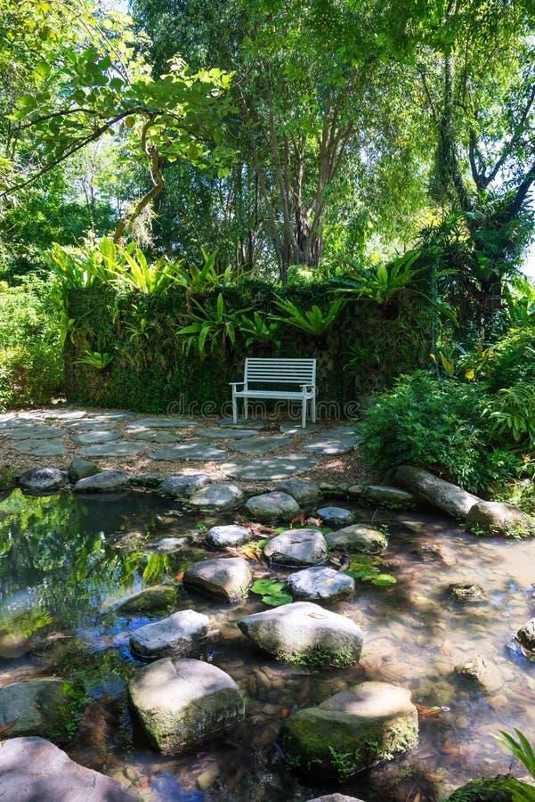 Classical White Bench in Beautiful Tropical Garden beside Stream ...