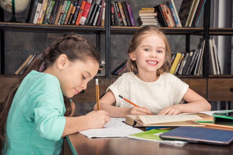 Classmates Doing Homework Together in Library Stock Image - Image of ...