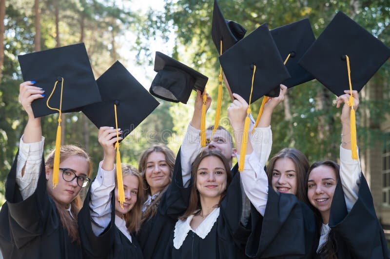 Classmates Graduation Gowns Throwing Hats Outdoors Stock Photos - Free ...