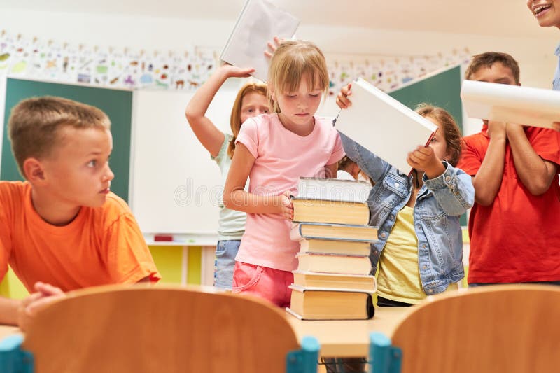 Classmates Stacking Books on Bench in Class Stock Image - Image of ...