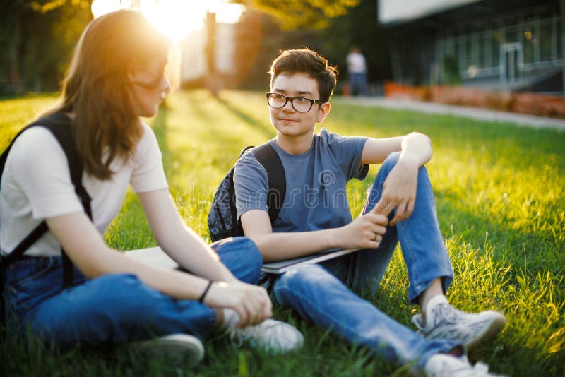 Classmates Talking on the Grass of the School Yard Stock Photo - Image ...