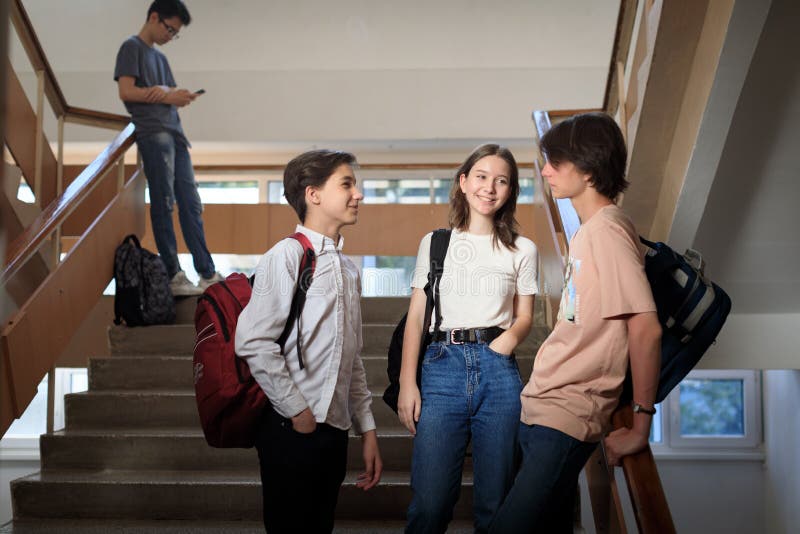 Classmates Talking on a Bench of the School Yard Stock Photo - Image of ...