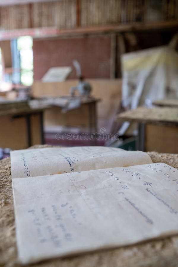 Classroom in an Abandoned School with Notebooks on Desks in the ...