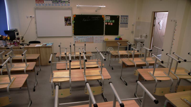 Classroom with Wooden Desks and Overturned Chairs To Wash Floor Stock ...