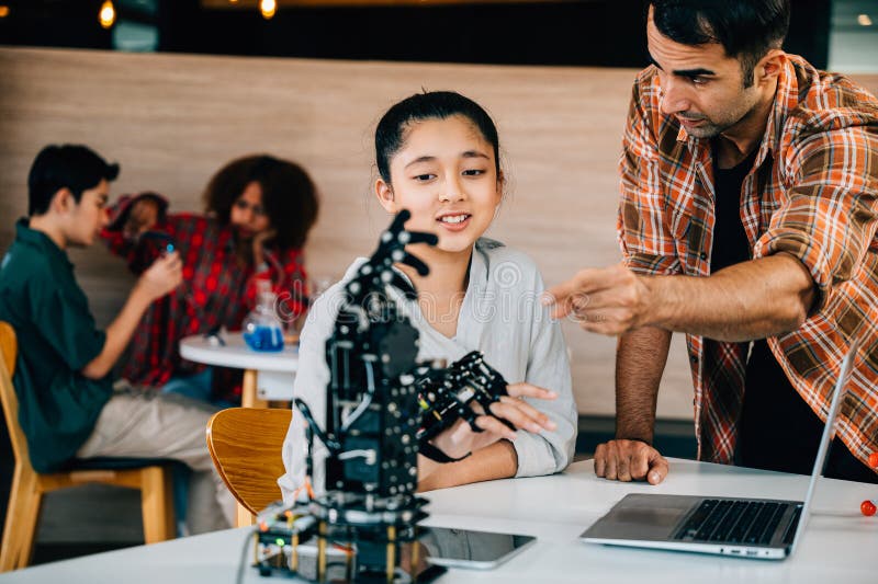 In Classroom Teacher Aids Student in Building Robotic Arm for Design ...