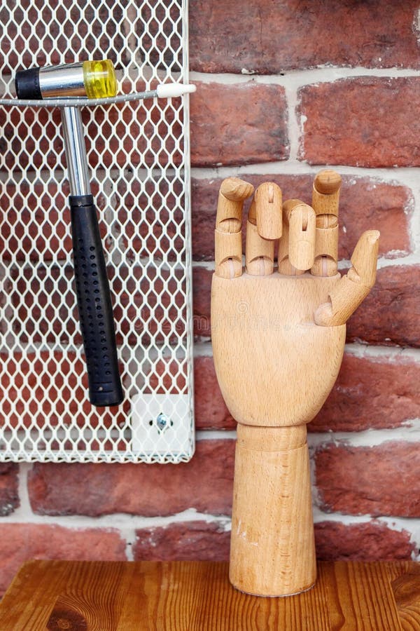 Claw Hammer and Jointed Wooden Hand Model on Wooden Table in a Jewelry ...