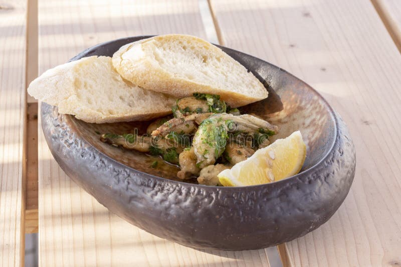 Clay Bowl with Roasted Frog Legs. Cooked Frog Legs. Stock Image - Image ...