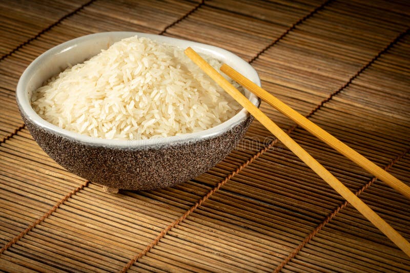 Clay Chinese Bowl with Rice and Chopsticks on a Bamboo Mat Stock Photo ...