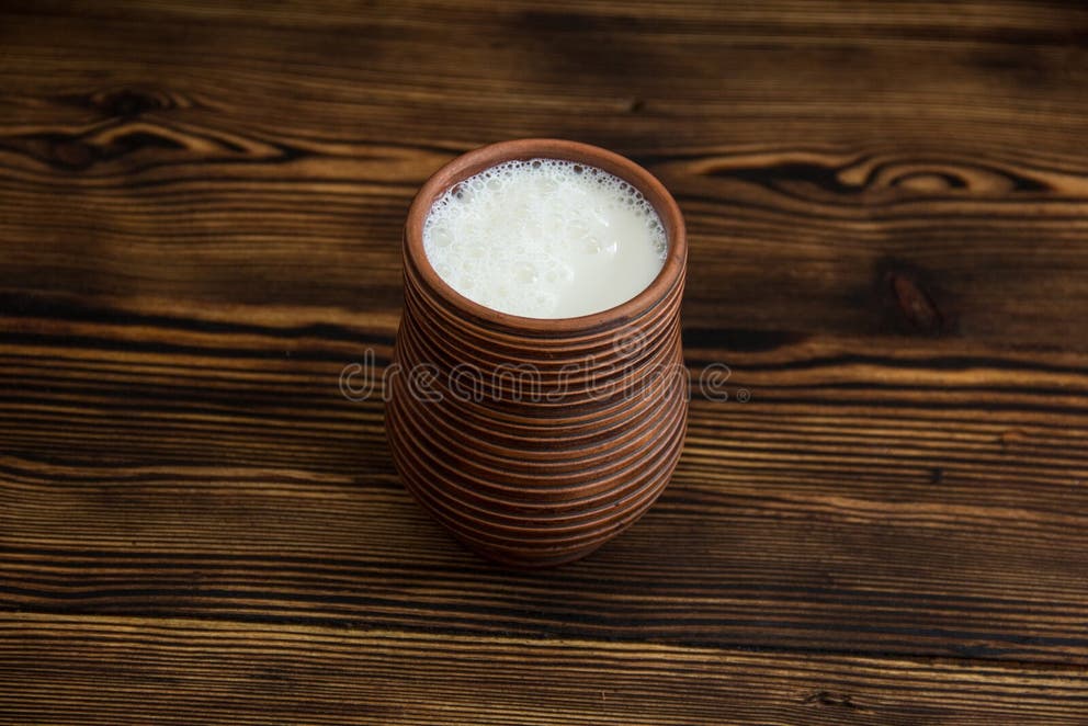Clay Glass with Milk on a Table Stock Image - Image of wooden, milk ...