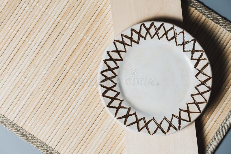 Clay Plate with Painting on Bamboo Mat. Stock Photo - Image of plate ...