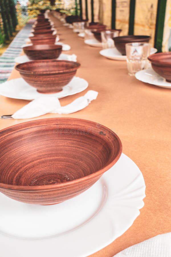 Clay Plates on a Long Table in an Outdoor Dining Area Stock Photo ...