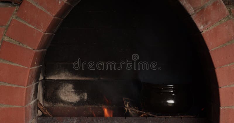 Clay Pot Placed Inside Rustic Oven with Vibrant Flames Growing Steadily ...