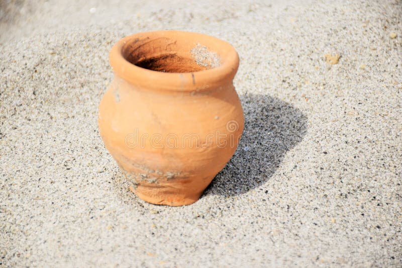 A clay pot on the sand stock photo. Image of carving - 271444386