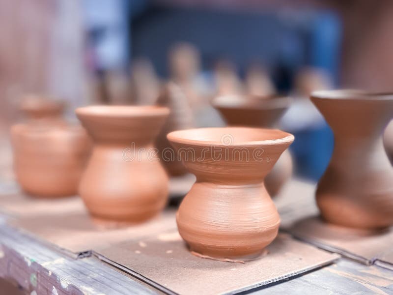 Clay Pots in Various Shapes on a Wooden Table at Pottery Workshop Stock ...