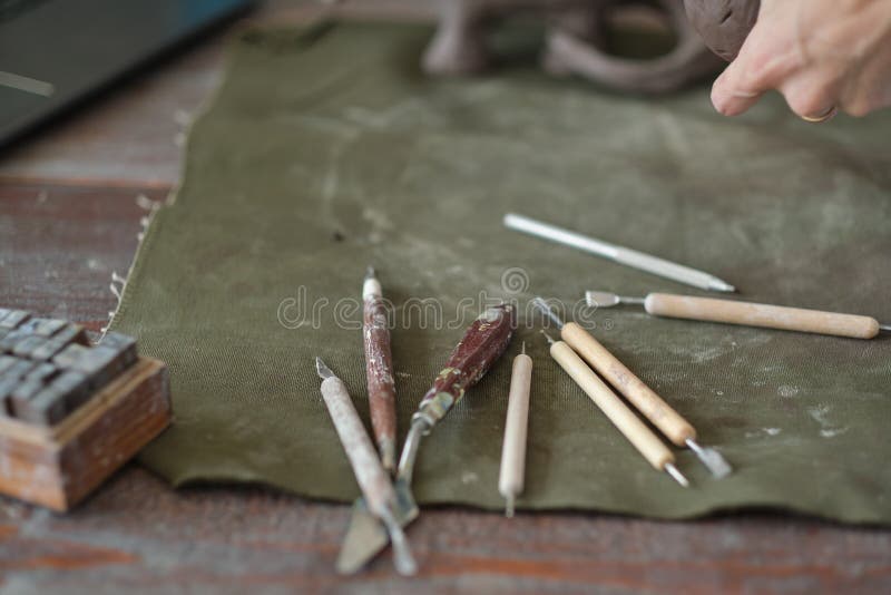 Clay and Tools are on the Table in Front of the Laptop. Ceramics Online ...