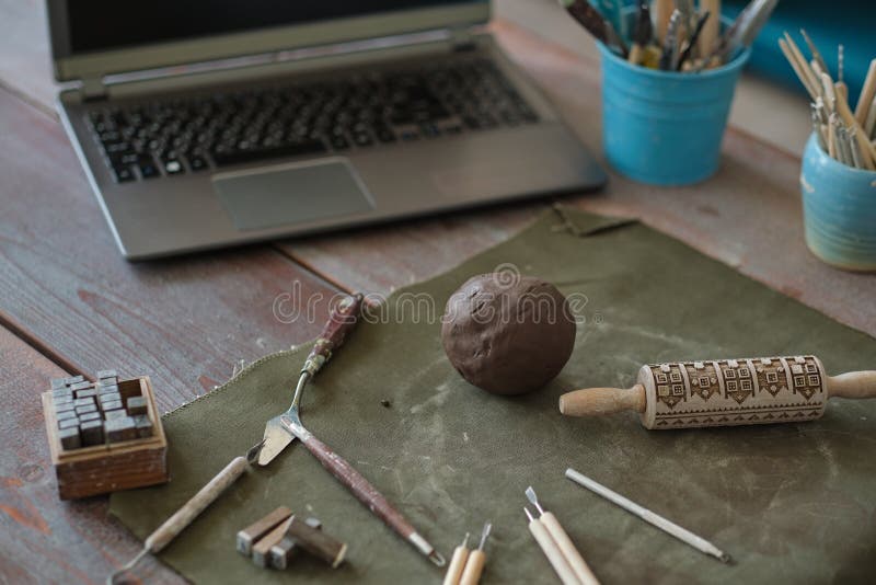 Clay and Tools are on the Table in Front of the Laptop. Ceramics Online ...