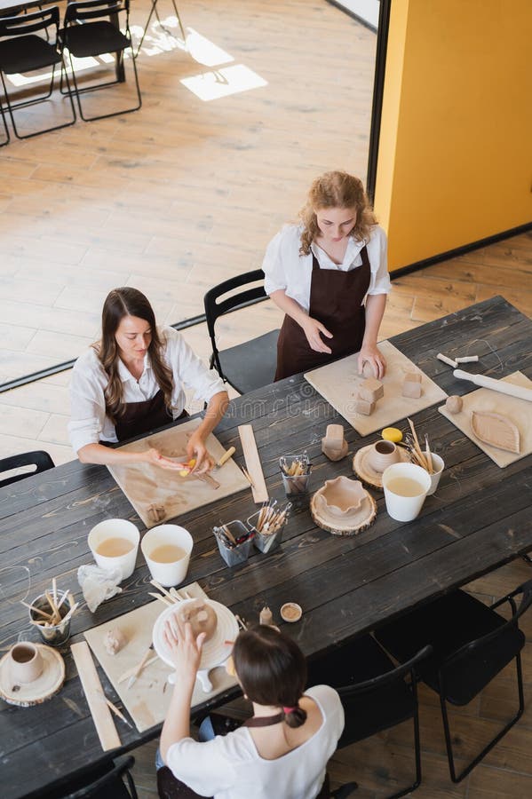 In the Clay Workshop. Female Potters Talking and Smiling during the ...