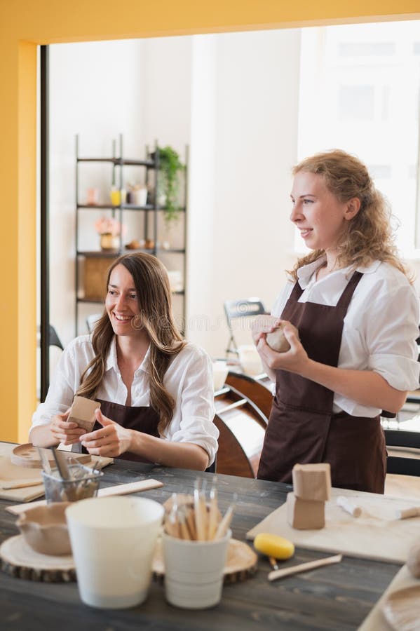In the Clay Workshop. Female Potters Talking and Smiling during the ...