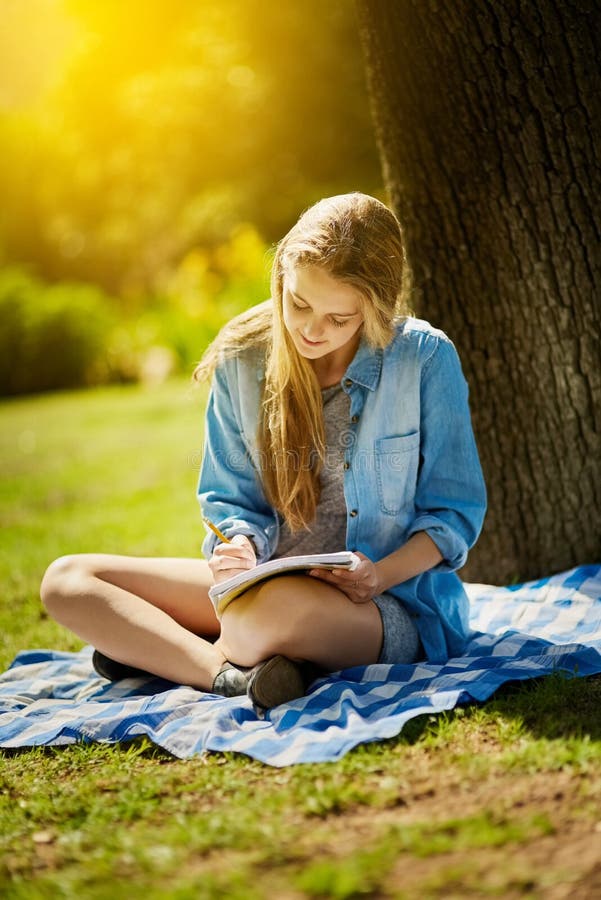 Clean Air Can Do You Good. a Young Student Studying Underneath a Tree ...