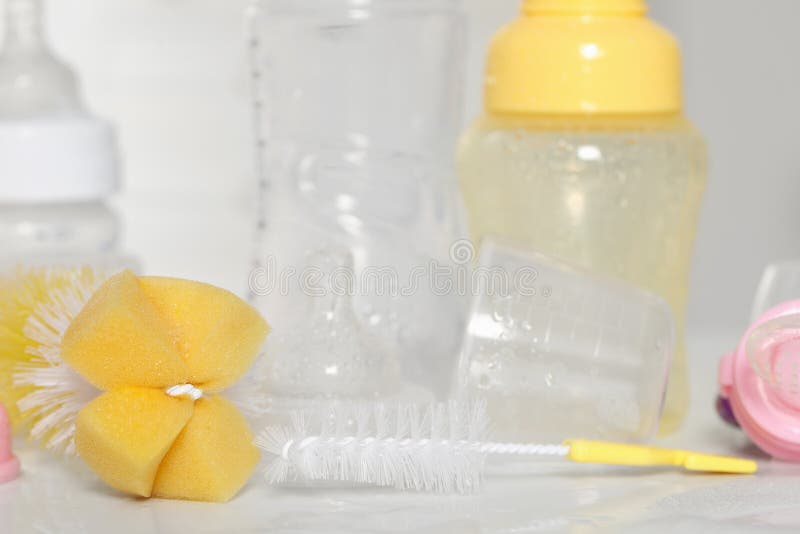 Clean Baby Bottles after Sterilization Near Brushes on White Table ...