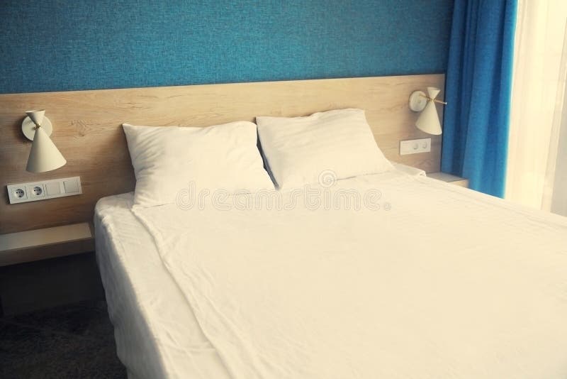 Clean Bed with White Sheet and Pillows in Hotel Stock Photo - Image of ...
