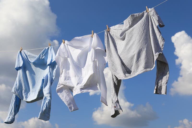 Clean Clothes Hanging on Washing Line Against Sky. Drying Laundry Stock ...