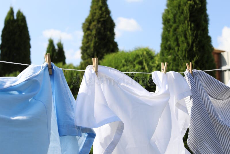 Clean Clothes Hanging on Washing Line Outdoors, Closeup. Drying Laundry ...