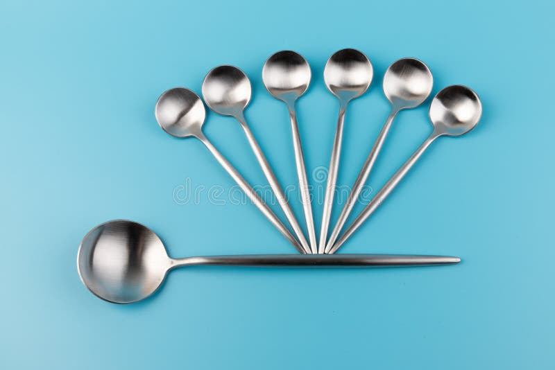 Clean Empty Big Table Spoon and Small Spoons on Blue Background, Top ...