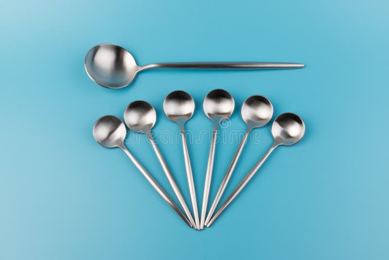 Clean Empty Big Table Spoon and Small Spoons on Blue Background, Top ...