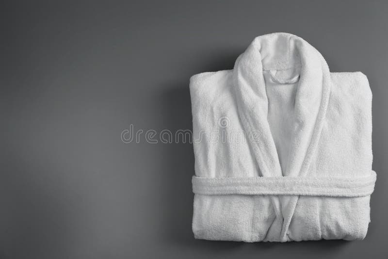 Folded Bathrobe on Bed in Room. White Robe Stock Photo - Image of ...