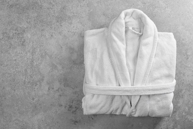 Folded Bathrobe on Bed in Room. White Robe Stock Photo - Image of ...
