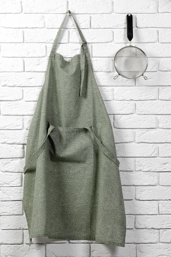 Clean Kitchen Apron with Pattern and Sieve on White Brick Wall Stock ...