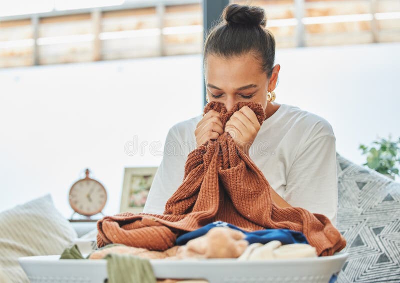Clean Laundry is the Best Smell. a Young Woman Sniffing a Clean Load of ...