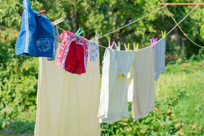Clean Laundry Drying on Line Outside Green Background Stock Photo ...