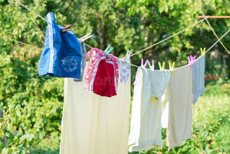 Clean Laundry Drying on Line Outside Green Background Stock Photo ...