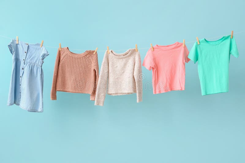 Clean Laundry Hanging on Line Against Color Background Stock Image ...