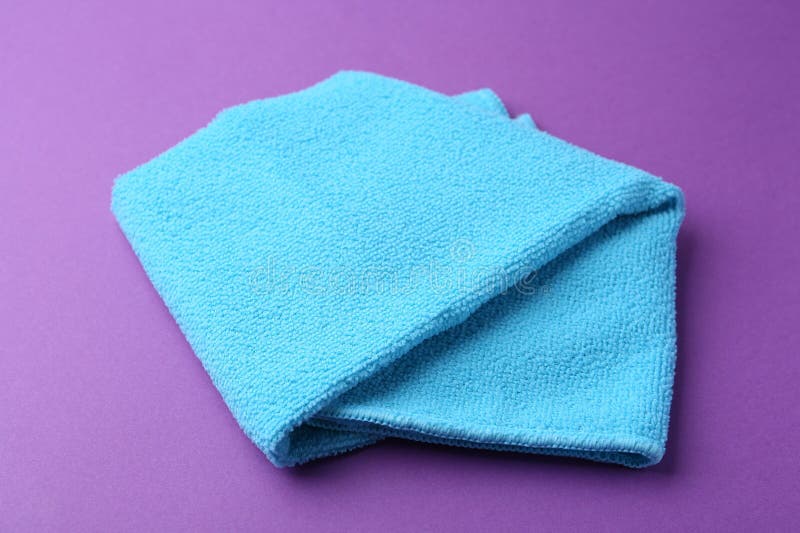 Clean Light Blue Microfiber Cloth on Purple Background, Closeup Stock ...