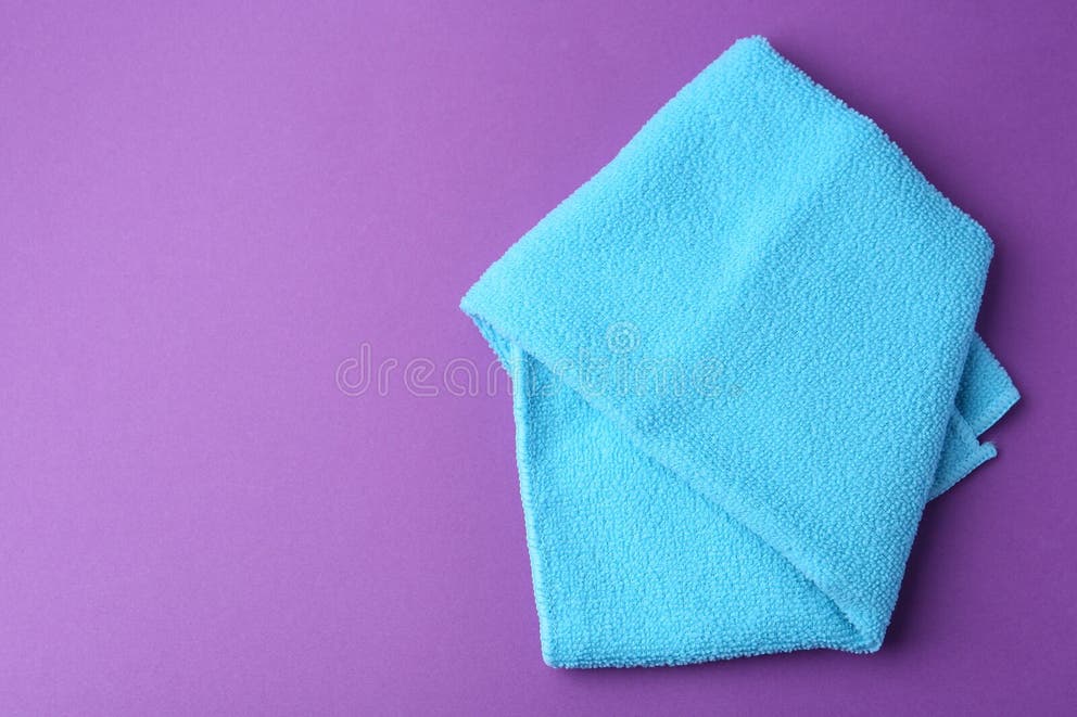 Clean Light Blue Microfiber Cloth on Purple Background, Top View. Space ...