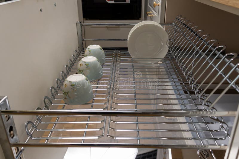 A Clean and Organized Kitchen Setup Featuring a Chrome Dish Rack with ...