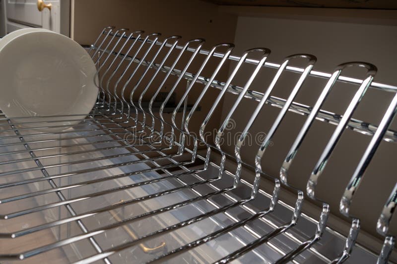 A Clean and Organized Kitchen Setup Featuring a Chrome Dish Rack with ...