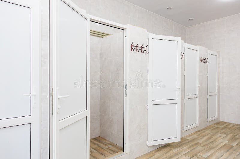 Clean Public Bathroom Stalls with Open White Doors and Tiled Walls ...