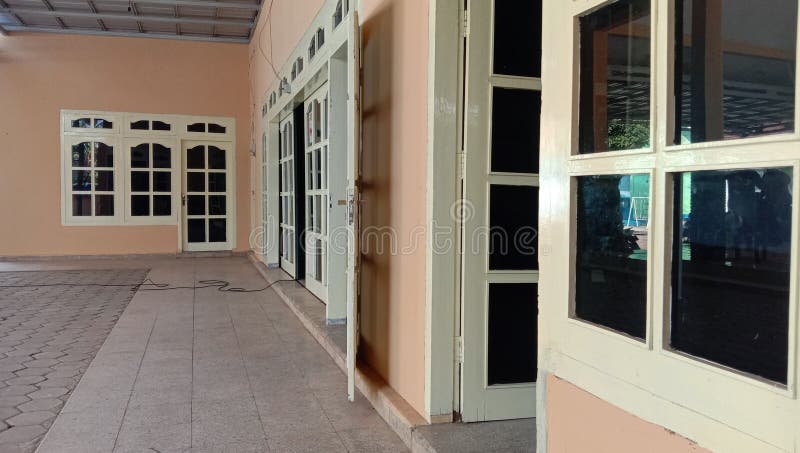 A Clean, Quiet Residential Terrace Corridor Featuring a Row of Cream ...