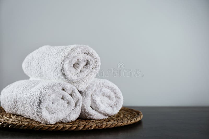 Clean Rolled Bath Towels and Wicker Mat on Grey Table. Space for Text ...