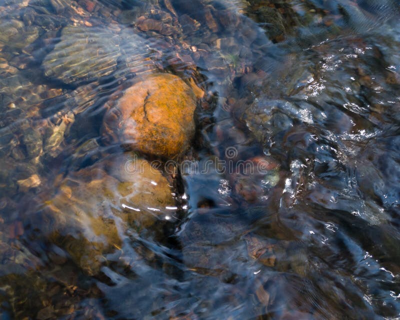 Clean Shallow Creek Water Flow Over Orange Stones Stock Image - Image ...