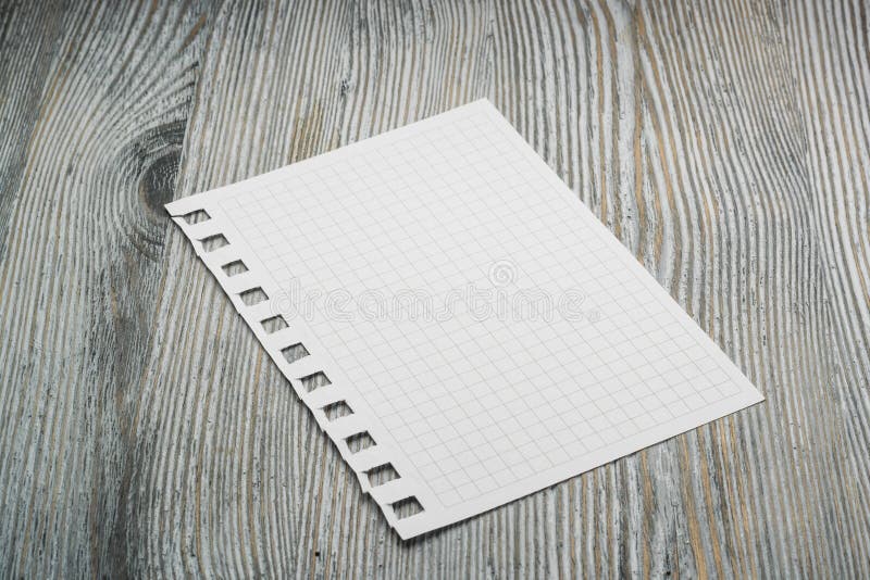 Clean Sheet in Cell from Notebook on Rustic Table. Stock Image - Image ...