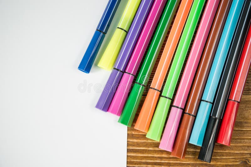 On the Table are Markers, Paper Clips and a Notebook with the ...