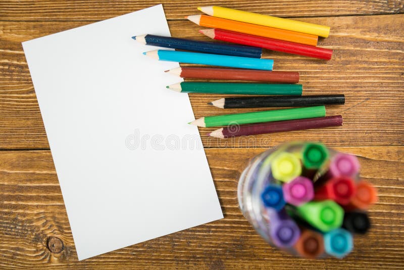 On the Table are Markers, Paper Clips and a Notebook with the ...