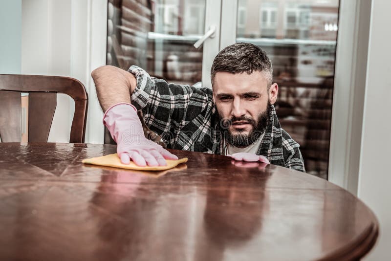 Pleasant Nice Man Cleaning the Table in the House Stock Photo - Image ...
